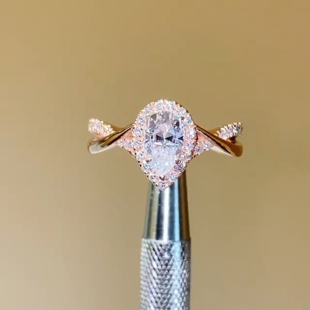 Pear Cut Intertwined Halo Engagement Ring in Gold | SayaBling